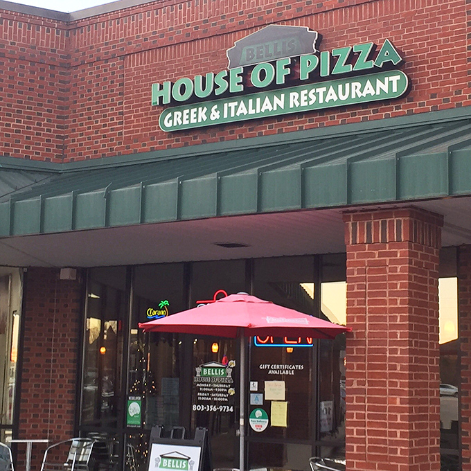 Bellis House of Pizza announces itself with confidence. The brick facade and green awning promise traditional flavors with Greek flair.