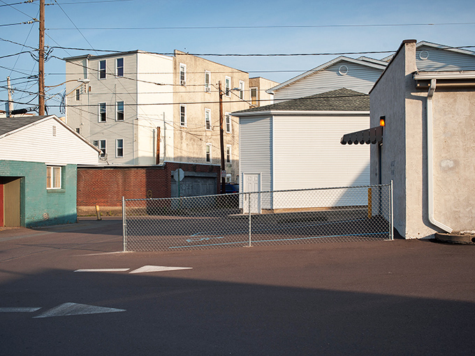 Urban haiku! Bloomsburg's fenced lot and utility poles create an oddly compelling composition that's part Edward Hopper, part modern art.