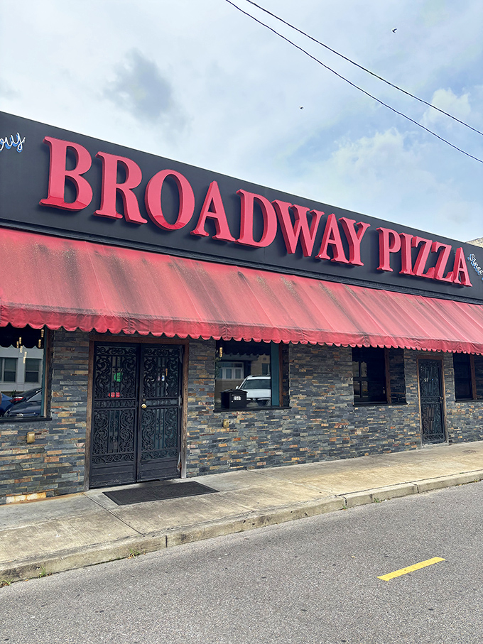 Broadway Pizza's stone facade and red awning stand like a Memphis institution. The kind of place where pizza recipes outlast fashion trends.