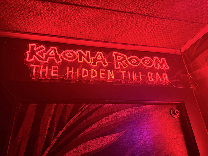 That crimson neon glow whispers "hidden speakeasy" louder than any secret password ever could in this mysterious retreat.