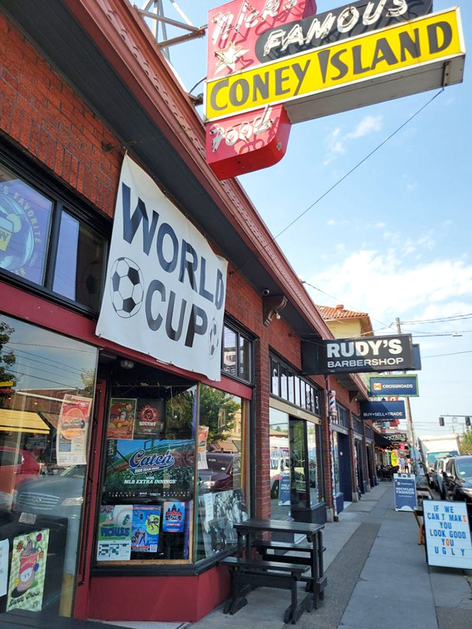 That vintage neon sign has been guiding hungry travelers for generations. World Cup banner means you can catch the game while catching up on your hot dog quota.