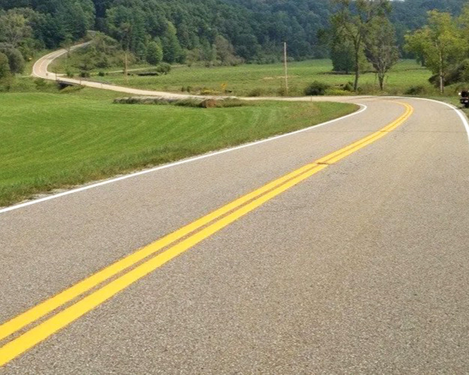The infamous "Triple Nickel" (Route 555) zigzags through Ohio's hills like a roller coaster designed by Mother Nature herself.