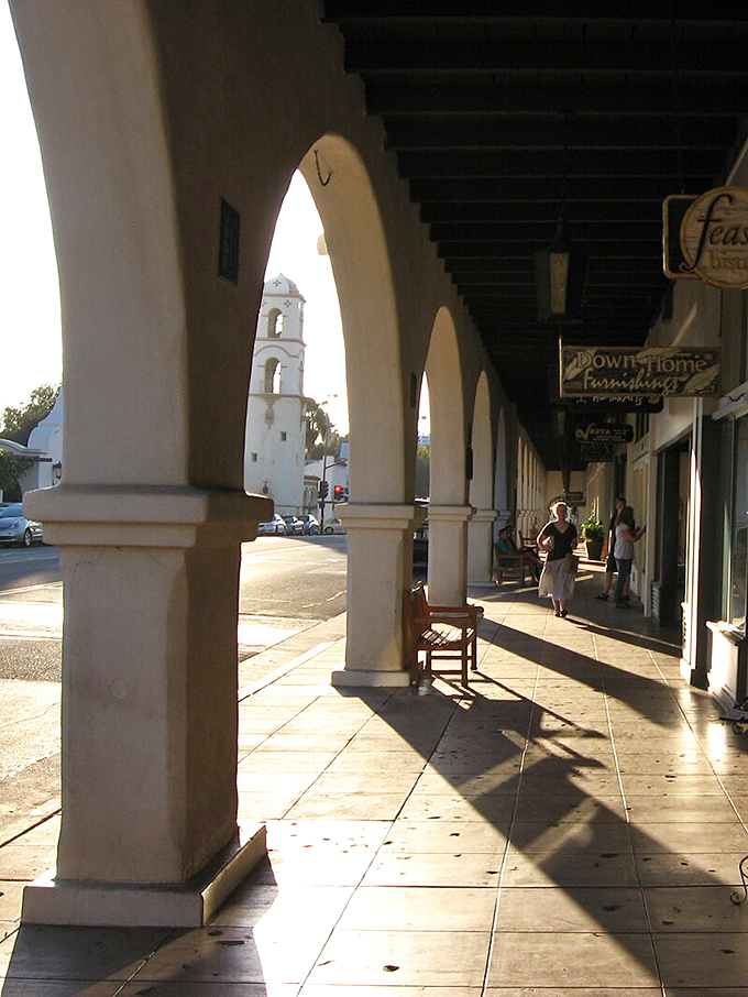 Ojai's Spanish-style arcades create cool shadows against the hot California sun, perfect for afternoon strolls and window shopping.