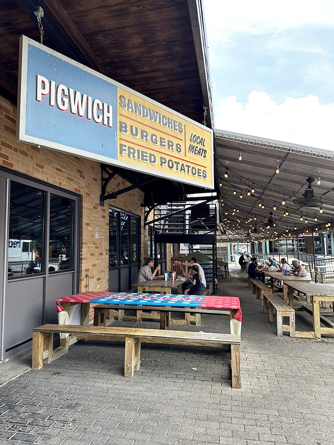 Picnic tables and string lights create the perfect casual vibe for enjoying Pigwich's meat-centric sandwich masterpieces.