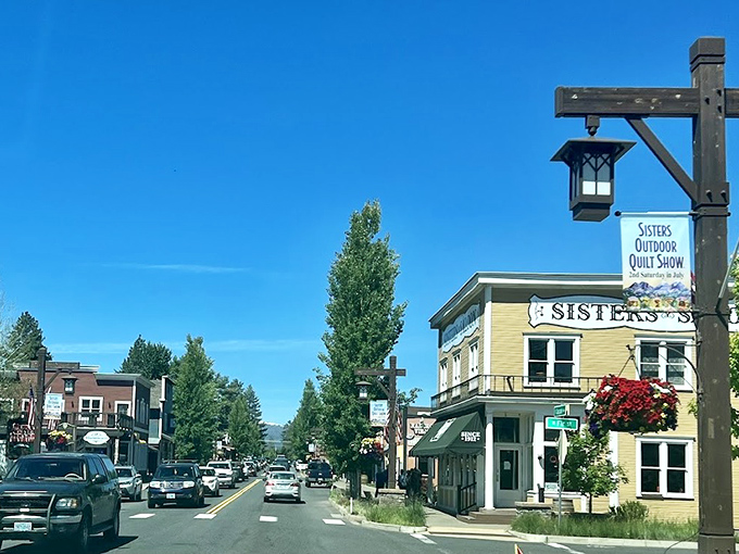 Blue skies frame this Western-themed main street, where hanging flower baskets add splashes of color to the mountain town.