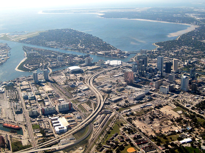 Tampa's downtown skyline reflects in the water. Big city energy with pockets of surprising affordability.