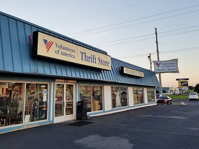 The blue-trimmed VOA store glows invitingly at dusk, tempting evening bargain hunters to stop in.
