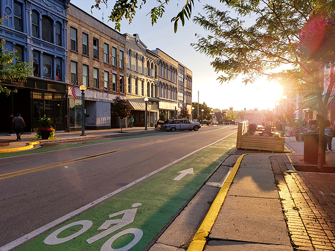 Morning light bathes Adrian's historic buildings in golden warmth, highlighting the affordable small-town charm that makes $1,850 stretch surprisingly far.