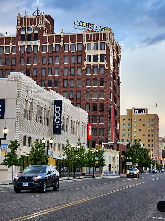 The historic Courtyard building glows with timeless style as Amarillo&rsquo;s downtown bustles below, blending classic architecture with a lively Texas spirit.