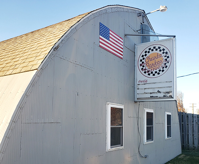 The curved metal roof of Charlie Parker's Diner gleams in the sunlight. Where breakfast is served with a side of architectural conversation.
