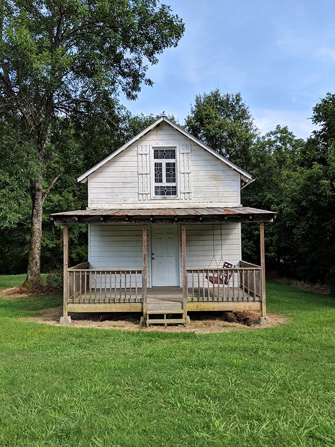 Simple white clapboard with a porch made for contemplation. Country living distilled to its essence in Euharlee.