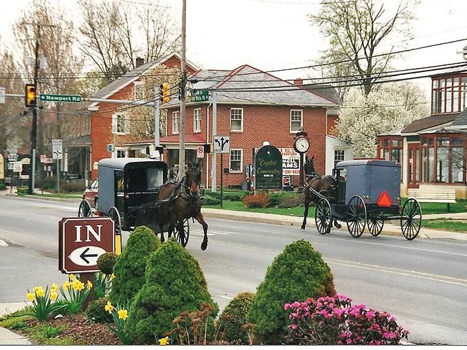 Spring blossoms and colorful flowers frame Intercourse's main street where Amish buggies regularly share the road with cars.