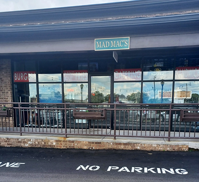 That unassuming patio is where gourmet sandwich dreams come true. The "NO PARKING" sign? Just saving space for more customers.
