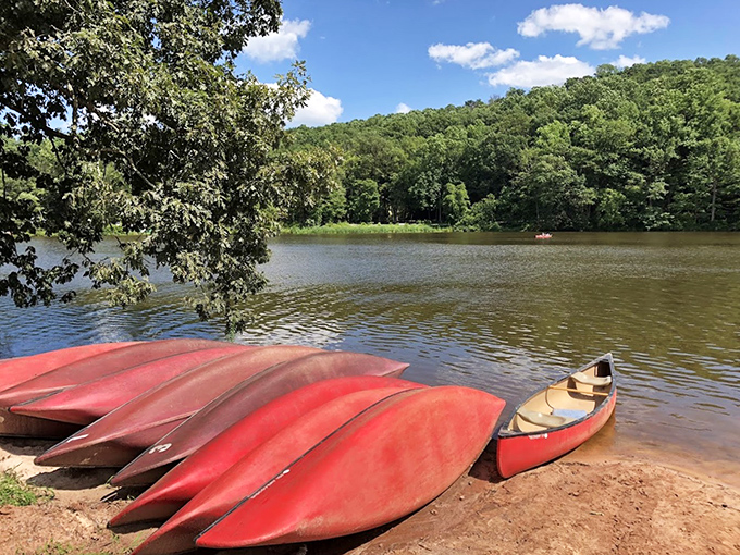 Red canoes line the shore at Mount Gretna, ready to carry explorers across waters that sparkle like liquid diamonds.