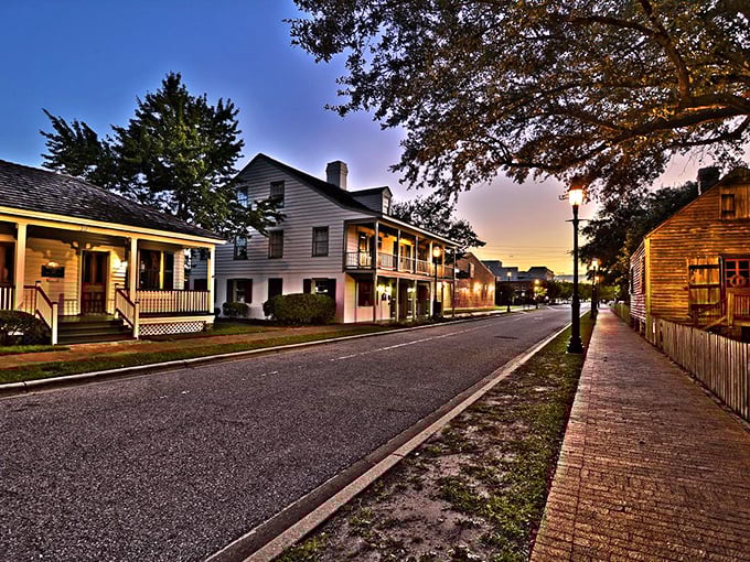 Pensacola's historic homes with wide porches line a quiet street at sunset, showcasing affordable living with small-town charm.
