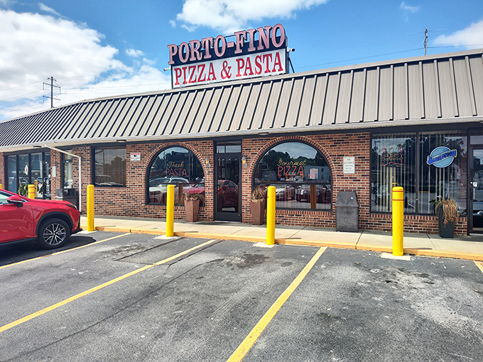 Porto-Fino's brick facade and yellow safety posts stand guard over pizza treasures. Worth navigating any parking lot for.