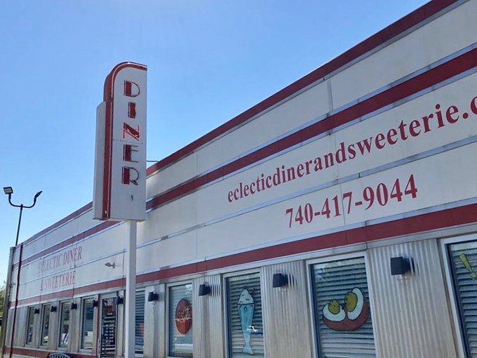 The towering "DINER" sign stands proud like a lighthouse guiding hungry travelers to their next great meal adventure.