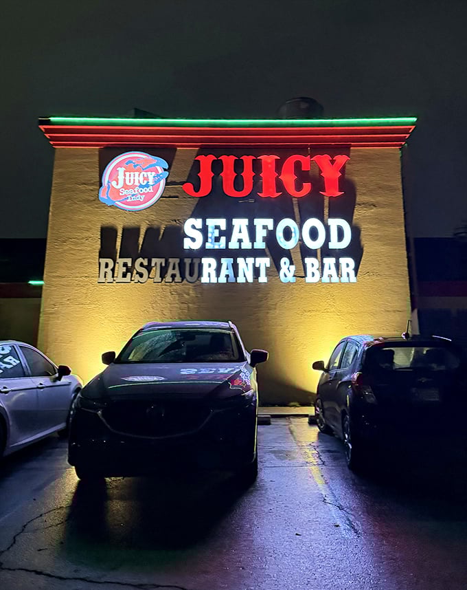 Night transforms The Juicy Seafood into a neon-lit seafood sanctuary. That illuminated sign is basically a bat signal for crab lovers!