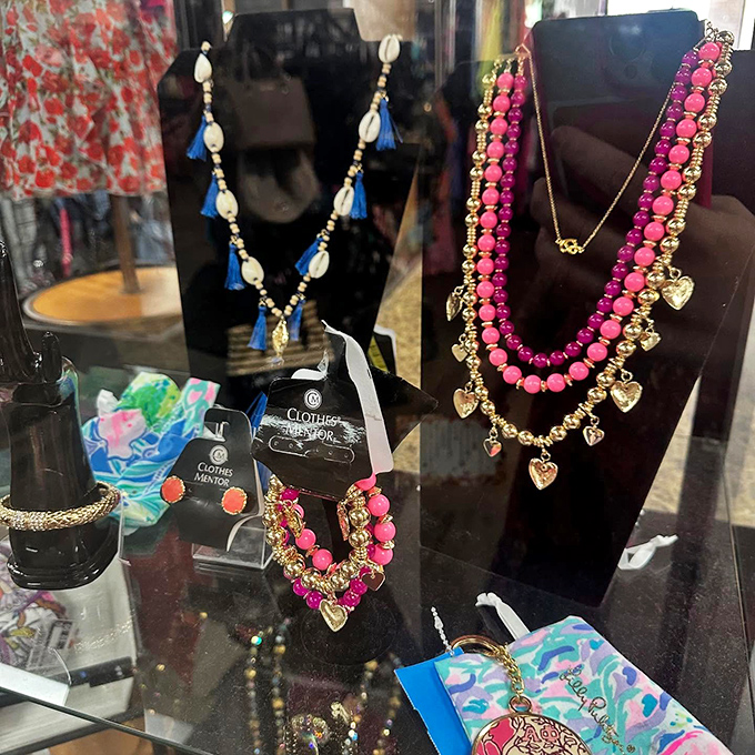 The accessories wall: where necklaces that once graced department store displays now wait for their second chance at glamour.