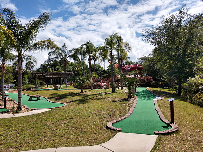 Mini-golf in paradise! Palm trees frame these perfectly manicured putting greens where family rivalries heat up faster than Florida asphalt in August.