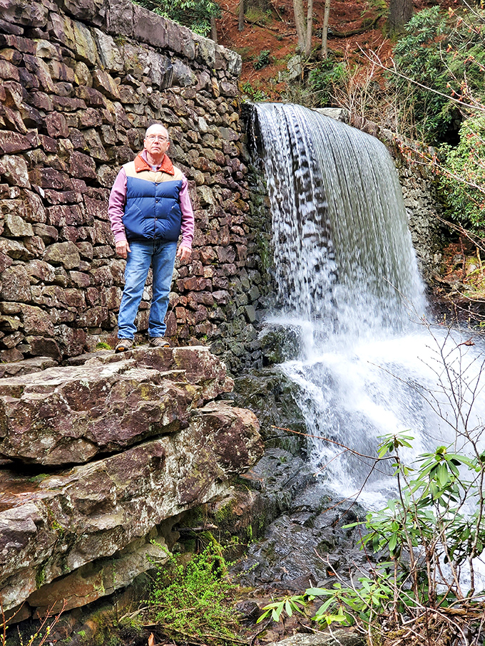 Stone walls frame cascading waters, showcasing the Civilian Conservation Corps' enduring craftsmanship. Pennsylvania's past and present flow together beautifully here.