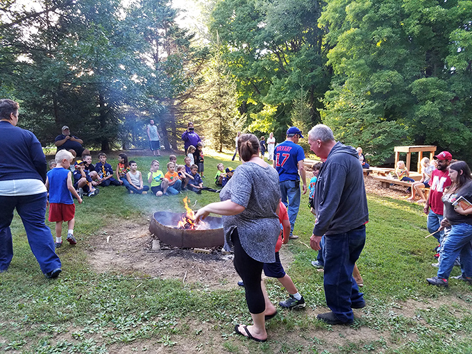 Gathered around flickering flames, park visitors create memories that will outlast even the most stubborn campfire smoke smell in their clothes.