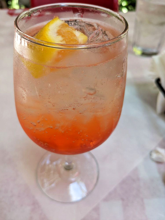 An Aperol Spritz that glows like a California sunset, because even Italian drinks go Hollywood here.