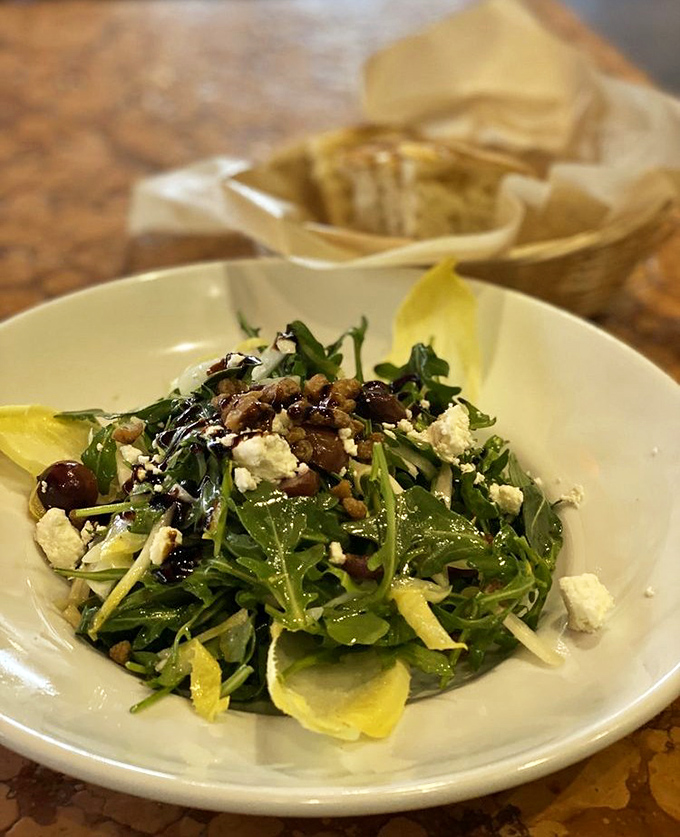 A salad that actually deserves to be ordered at a pasta restaurant&mdash;arugula, cheese, and olives playing together like old friends at a Mediterranean reunion.