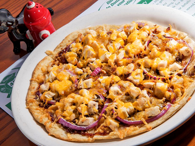 BBQ chicken pizza that doesn't skimp on the good stuff. Those purple onions cutting through the richness are the unsung heroes of this cheesy masterpiece.