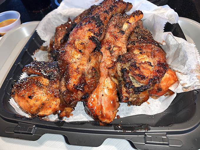 Chicken wings that look like they've been kissed by fire gods and blessed by the sauce deities. No dainty eating allowed.