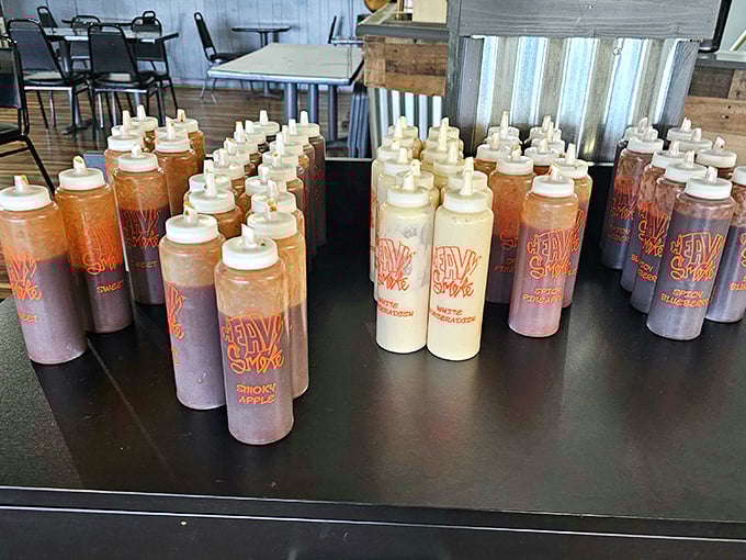 The sauce lineup at Heavy Smoke looks like a chemistry experiment gone deliciously right. From sweet to heat, these squeeze bottles hold liquid gold.