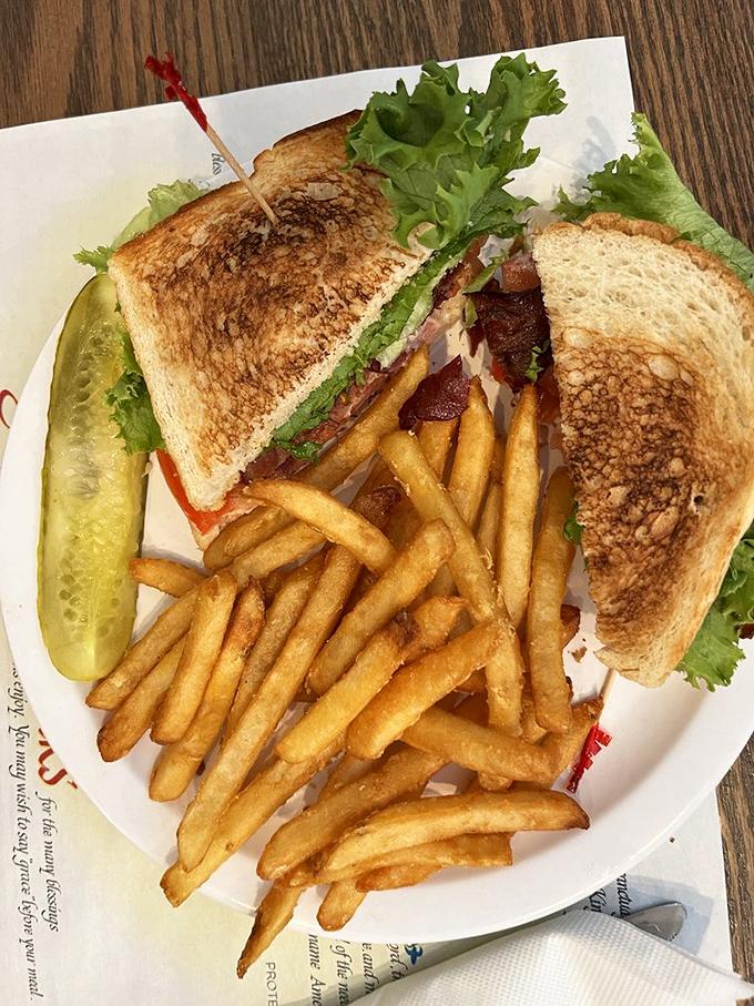 A sandwich that understands the importance of balance&mdash;perfectly toasted bread, crisp lettuce, and bacon cooked just right. Those golden fries aren't just a side, they're co-stars.