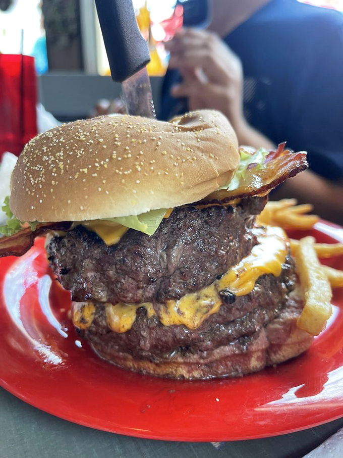 This isn't just a burger&mdash;it's a skyscraper of beef with melted cheese waterfalls. The kind of sandwich that requires jaw exercises and absolutely no first-date ordering.
