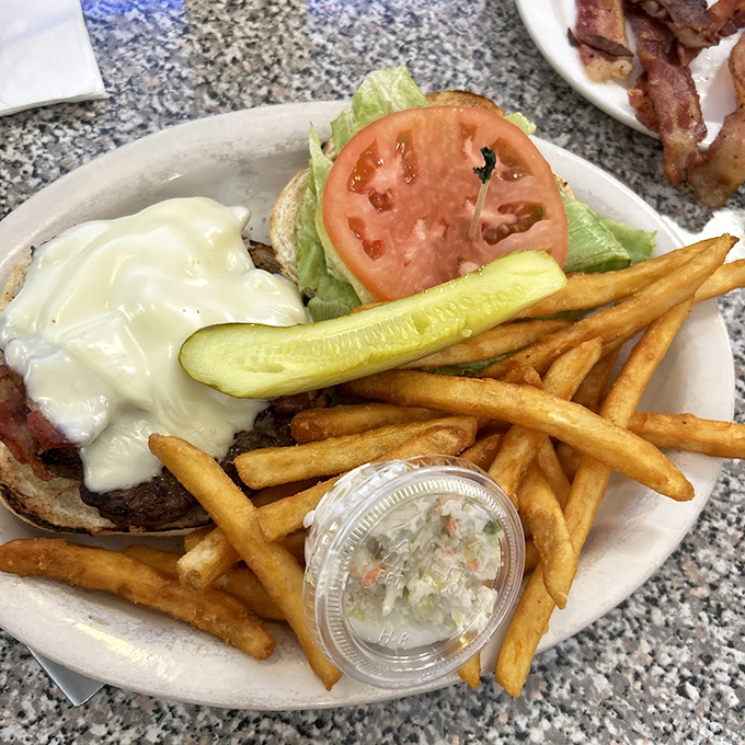 This bacon cheeseburger and fries combo delivers pure American diner satisfaction on every plate.