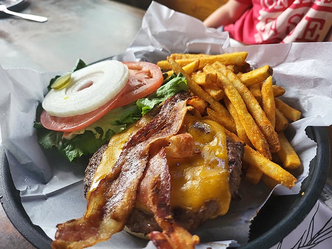 This isn't just a burger&mdash;it's architecture. The bacon forms perfect arches over melted cheese that's making a break for freedom.
