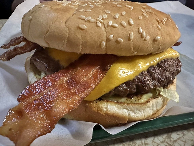 Bacon: the jewelry of the food world, draped elegantly across this cheeseburger like it's walking the red carpet at the Burger Awards.
