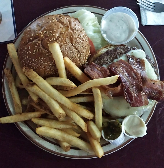 A burger that requires jaw exercises beforehand, accompanied by fries that could make a Frenchman weep with joy.