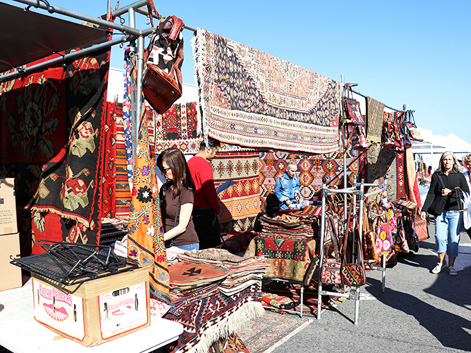 Persian rugs spread stories across asphalt while leather bags promise adventures in countries yet unexplored.