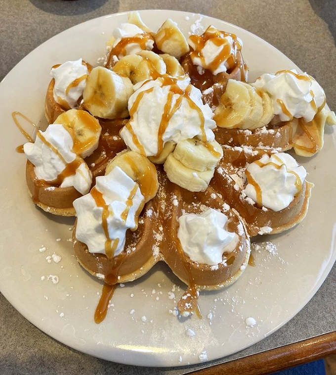 Banana-topped French toast with caramel drizzle and whipped cream&mdash;dessert masquerading as breakfast, and nobody's complaining.