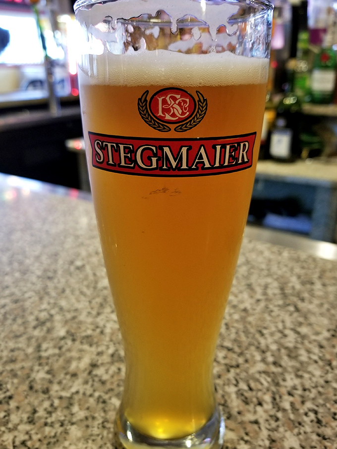 A perfectly poured Stegmaier stands ready to combat the heat of the pizza oven's offerings—the local brew's golden clarity promising refreshment with each sip.