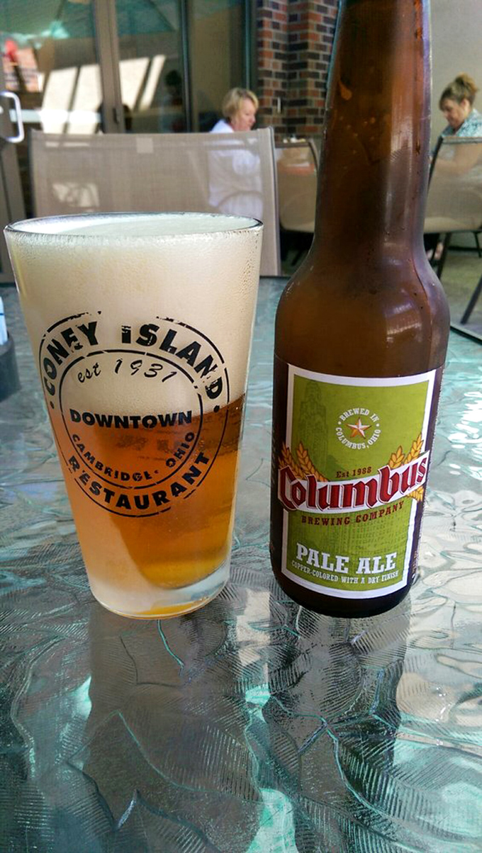 Local beer served in a glass that tells you exactly where you are—because sometimes the best pairing for good food is a sense of place.