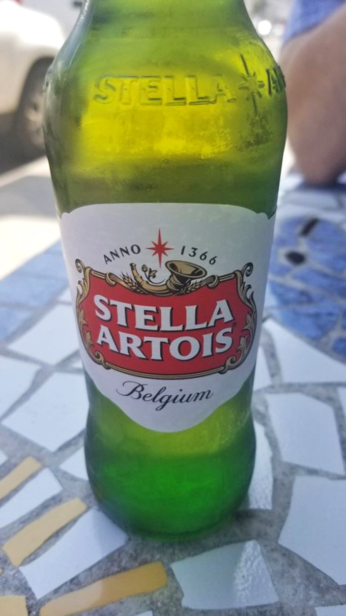 Nothing complements seafood like an ice-cold Stella. The condensation on the bottle mirrors the ocean view you're probably enjoying.
