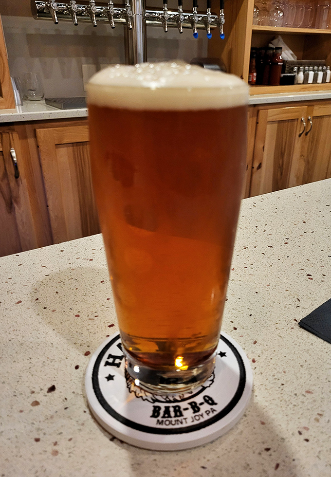 A cold craft beer in a Harvey's branded glass&mdash;because what pairs better with hours of smoked perfection than something that took similar patience to brew?