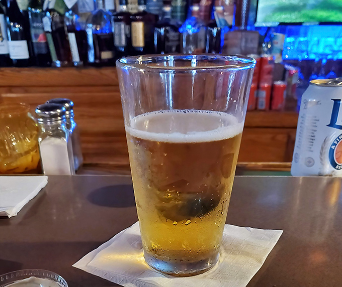 A perfectly poured beer catching the bar light just right&mdash;liquid amber waiting patiently while you debate between Asian Zing or Teschner's Fuego wings.