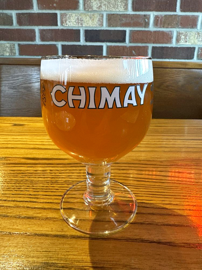 A proper Chimay served in its proper glass. Because sometimes the perfect pizza companion isn't another slice, but a Belgian brew with centuries of tradition.