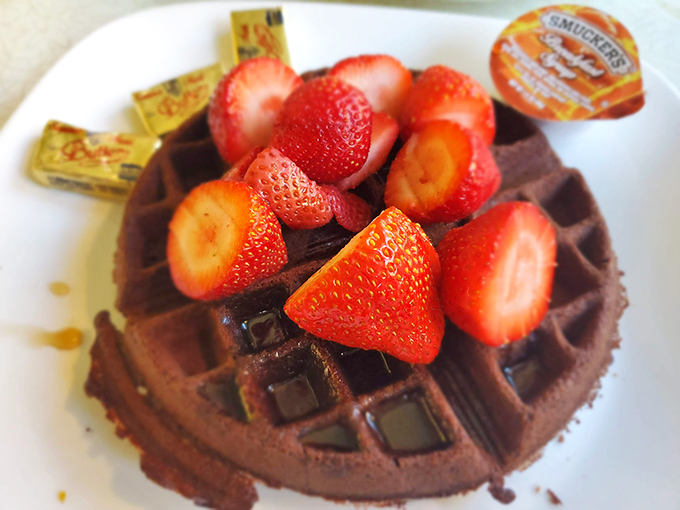 A chocolate waffle crowned with fresh strawberries &ndash; proof that breakfast and dessert are really just distant cousins.