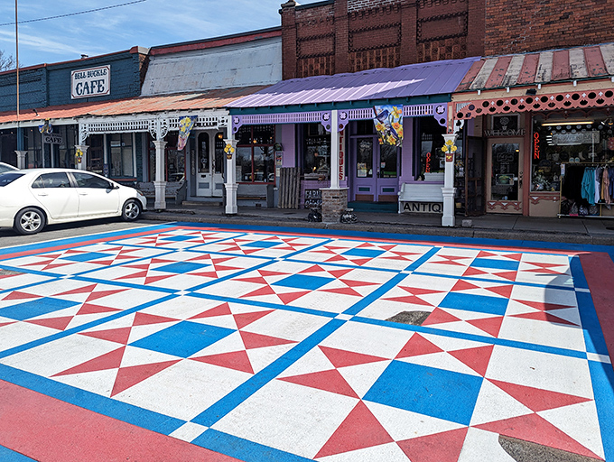 Morning light catches the ornate white columns and vibrant storefronts, where shopkeepers are already sweeping porches and brewing coffee.