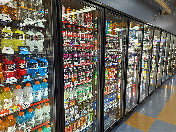 The beverage coolers stretch into infinity, a chilled oasis of refreshment options that somehow makes choosing just one feel like Sophie's Choice.
