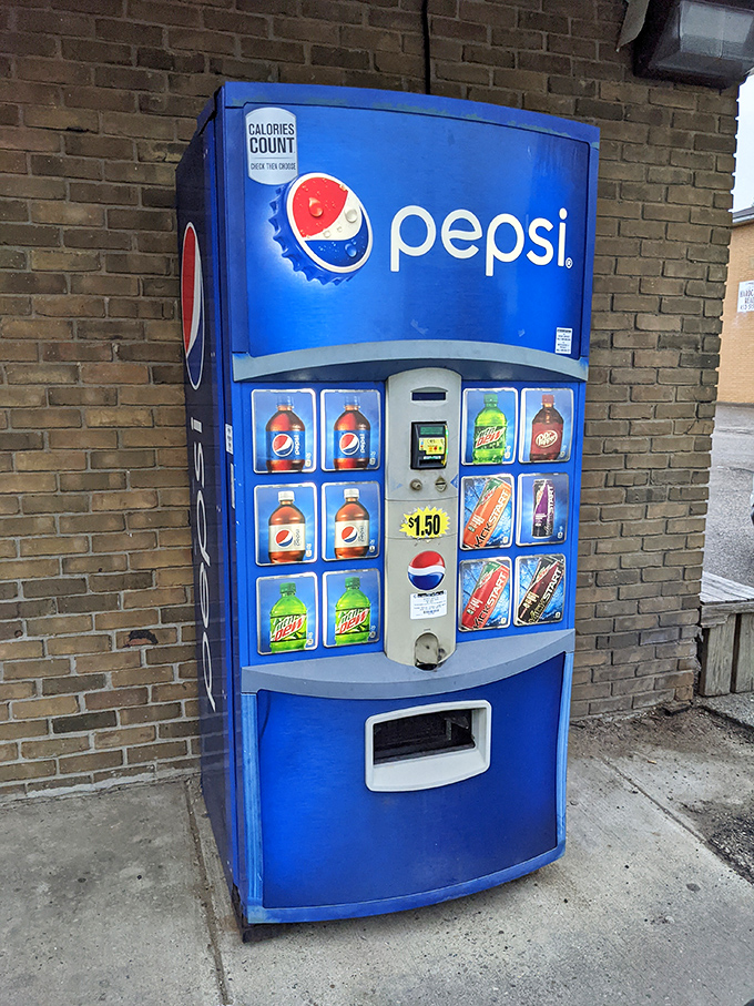 Even the Pepsi machine outside seems to understand its supporting role in the grand theater of donut consumption. Hydration is important, folks.