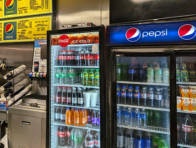 The beverage coolers stand ready like old friends, offering the perfect fizzy companion to cut through all that delicious cheese and sauce.